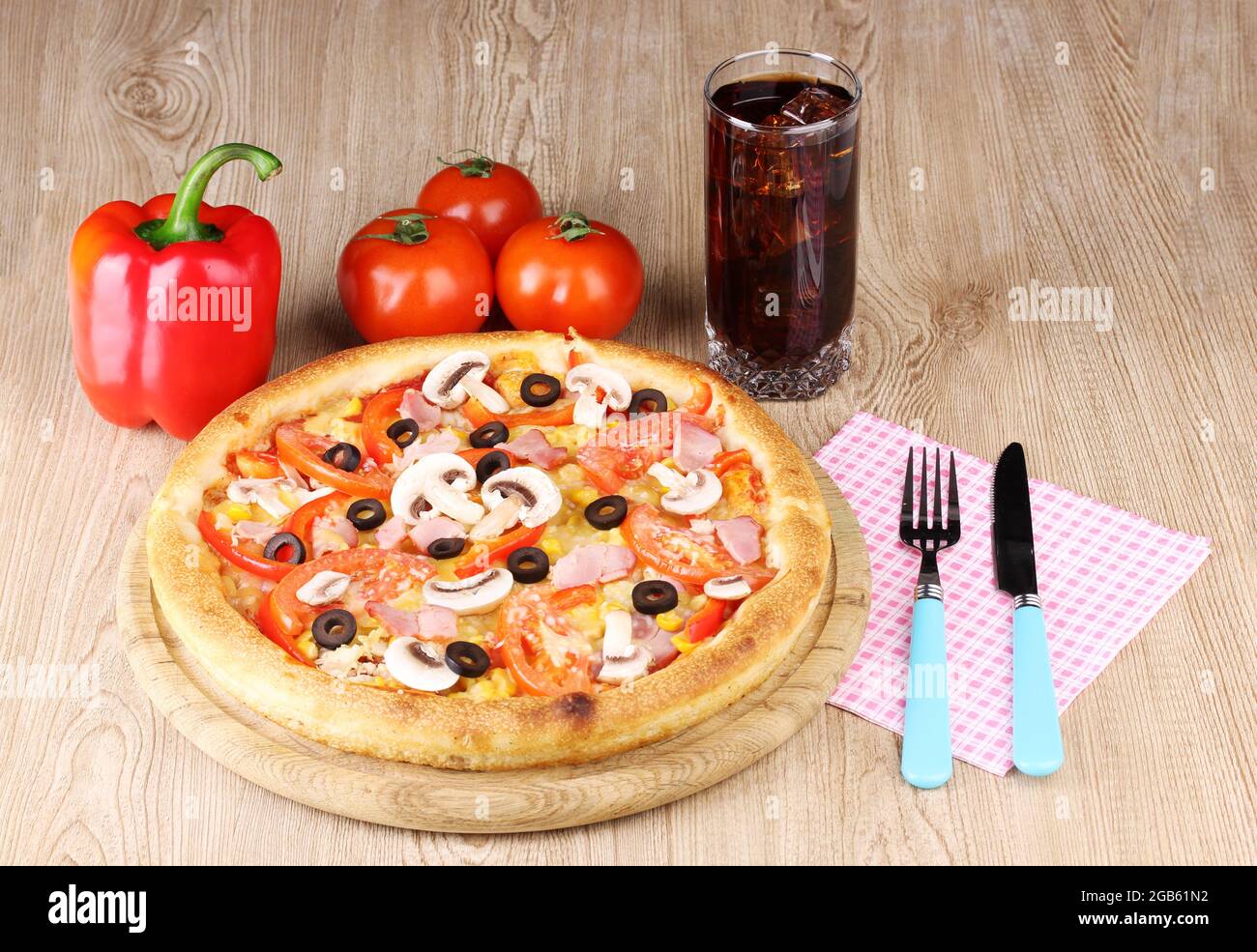 Aromatic pizza and cola on wooden background Stock Photo - Alamy