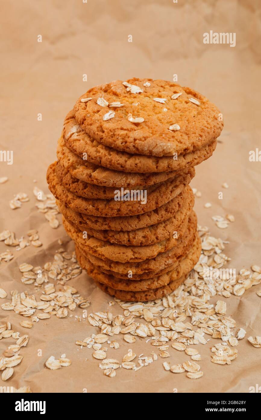 oatmeal cookies and scattered oatmeal on crumpled paper background ...
