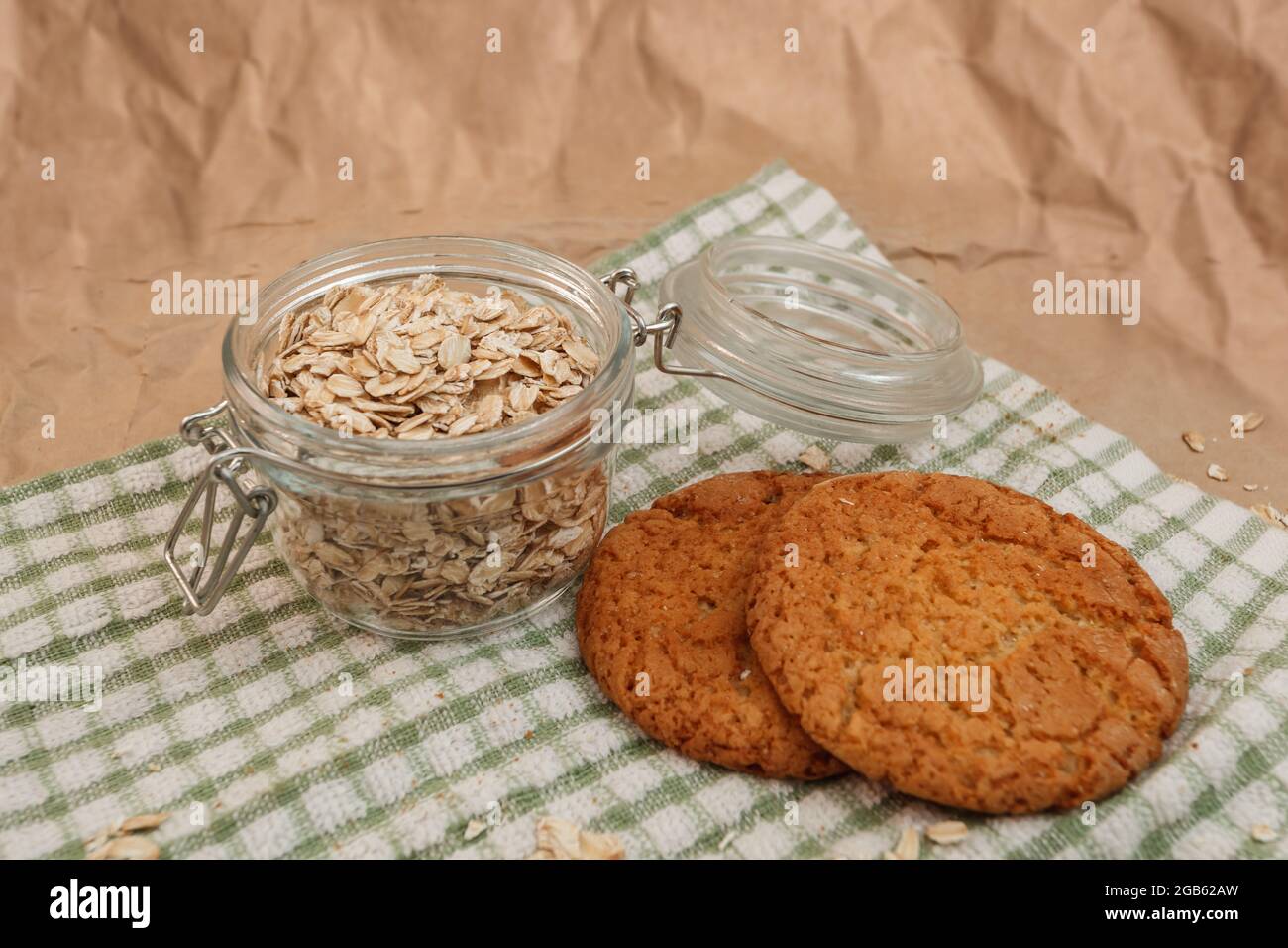 oatmeal cookies and scattered oatmeal on crumpled paper background ...