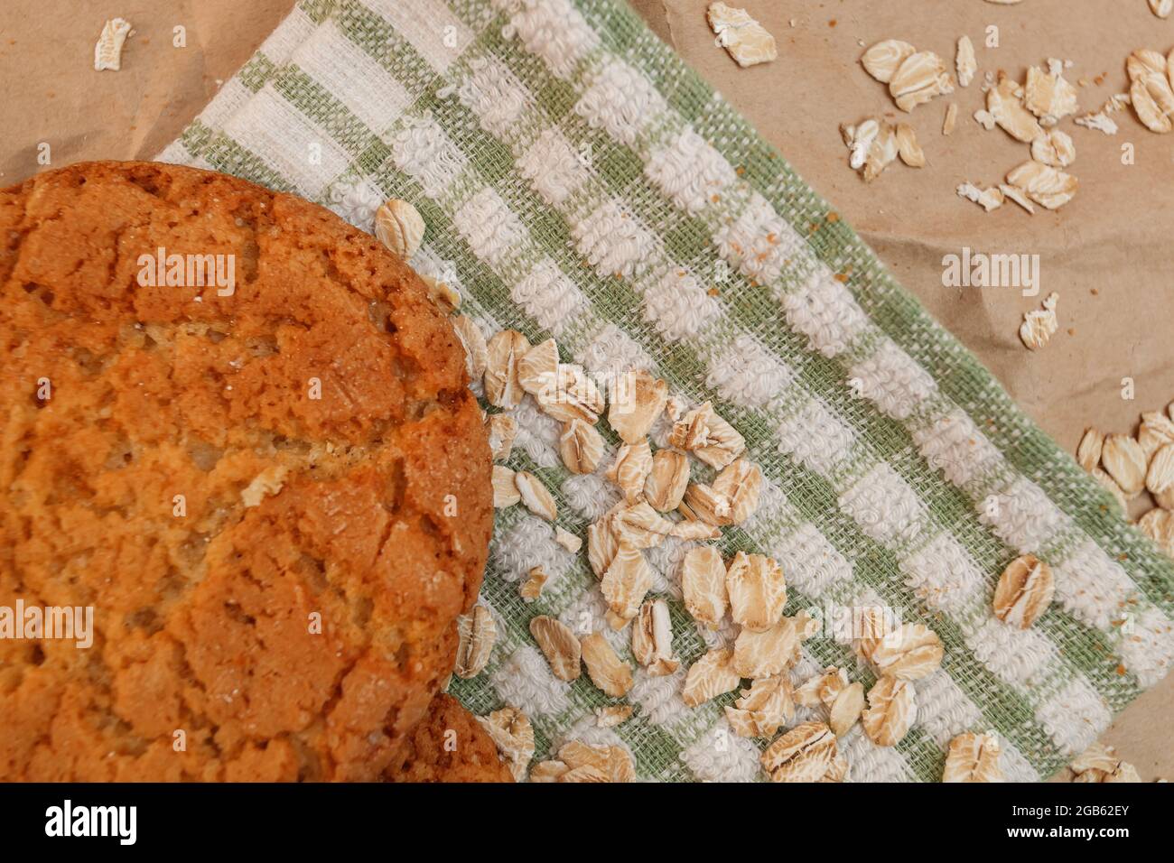 oatmeal cookies and scattered oatmeal on crumpled paper background ...