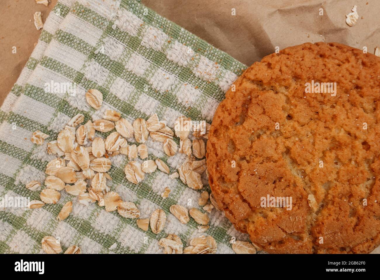 oatmeal cookies and scattered oatmeal on crumpled paper background ...