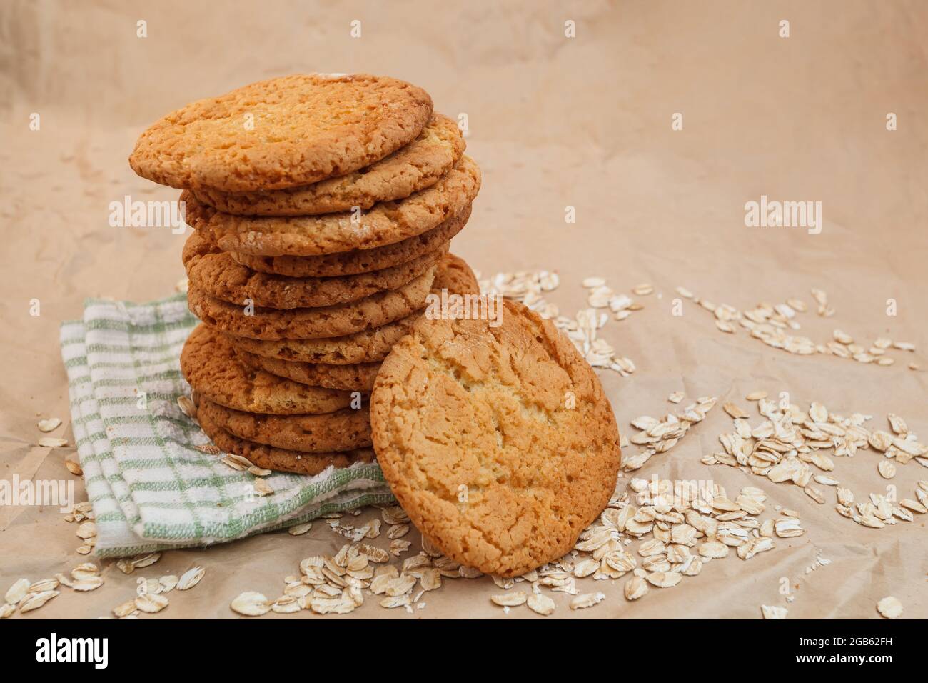oatmeal cookies and scattered oatmeal on crumpled paper background ...