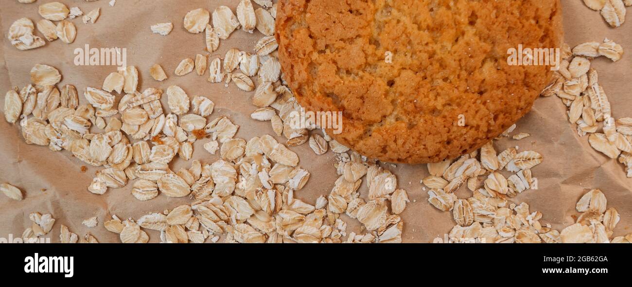 oatmeal cookies and oat flakes scattered on panaramnom background ...