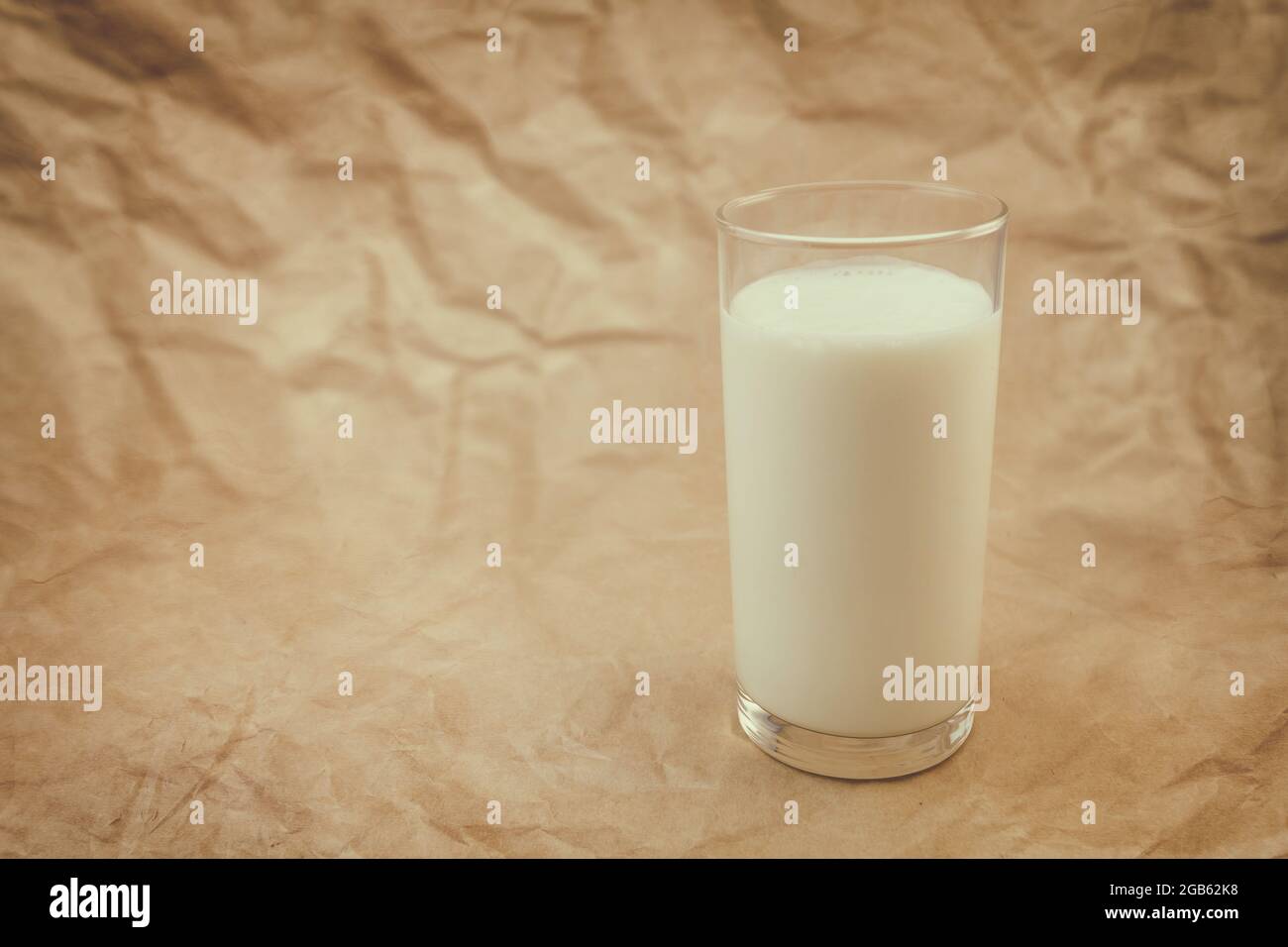 glass of milk on crumpled paper background Stock Photo - Alamy
