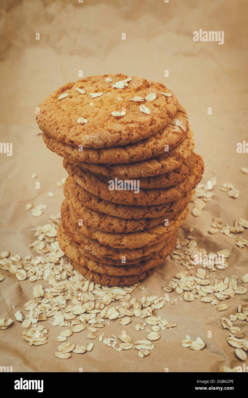 oatmeal cookies and scattered oatmeal on crumpled paper background ...