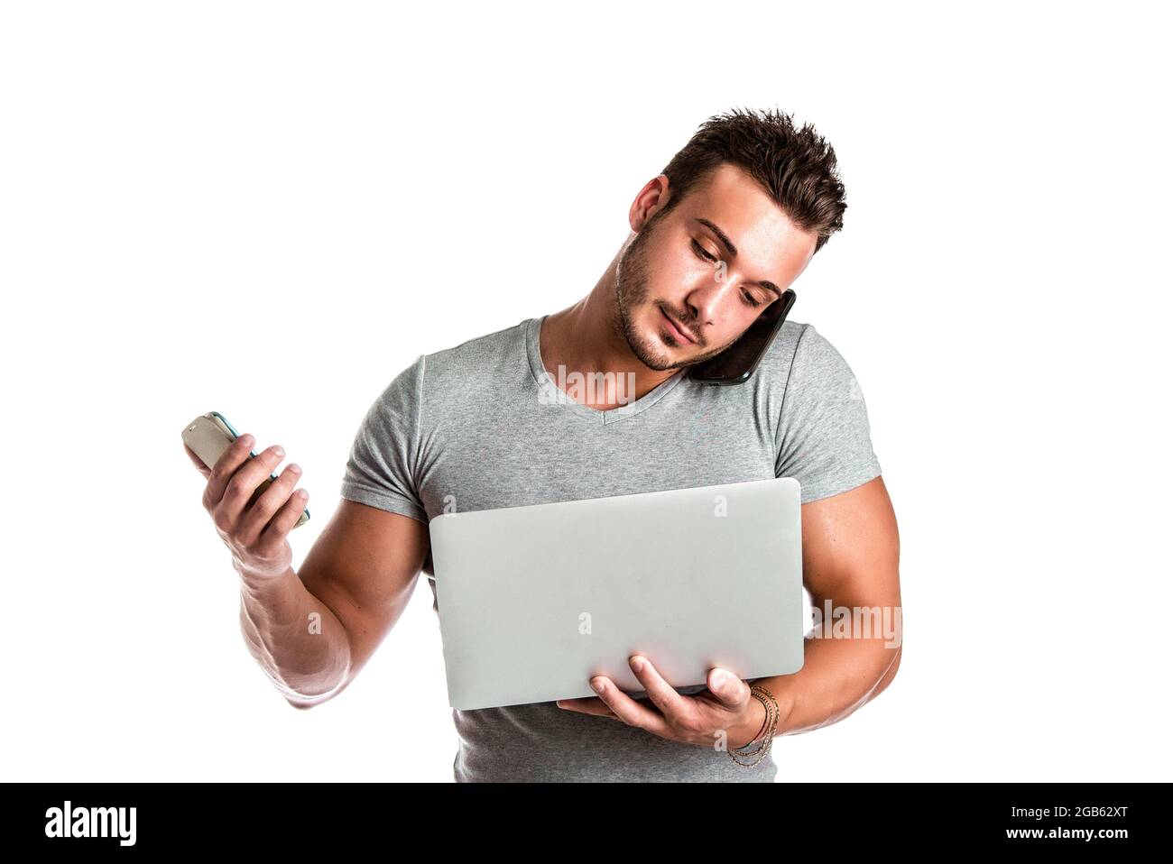 Young man using too many devices at the same time Stock Photo - Alamy