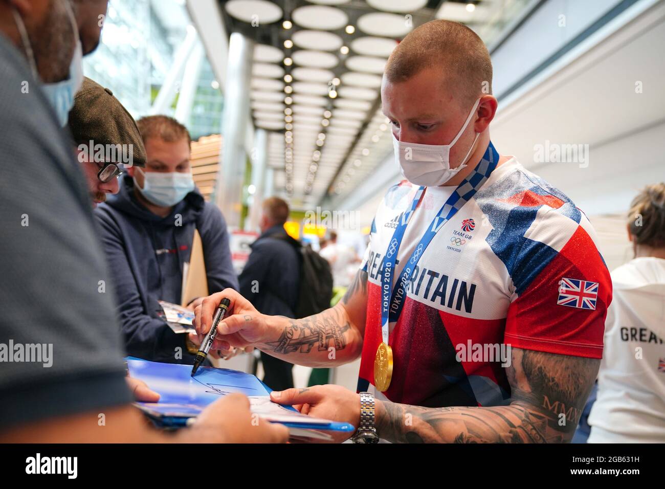 British swimmer Adam Peaty arrives back at London Heathrow Airport from ...