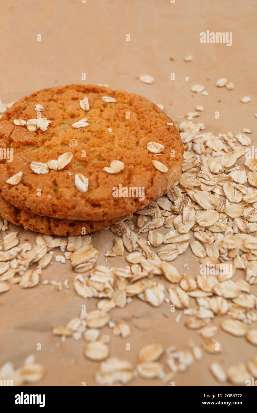 oatmeal cookies and scattered oatmeal on crumpled paper background ...