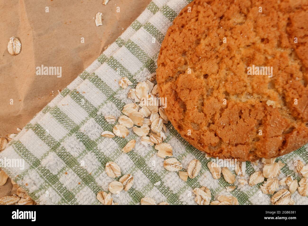 oatmeal cookies and scattered oatmeal on crumpled paper background ...