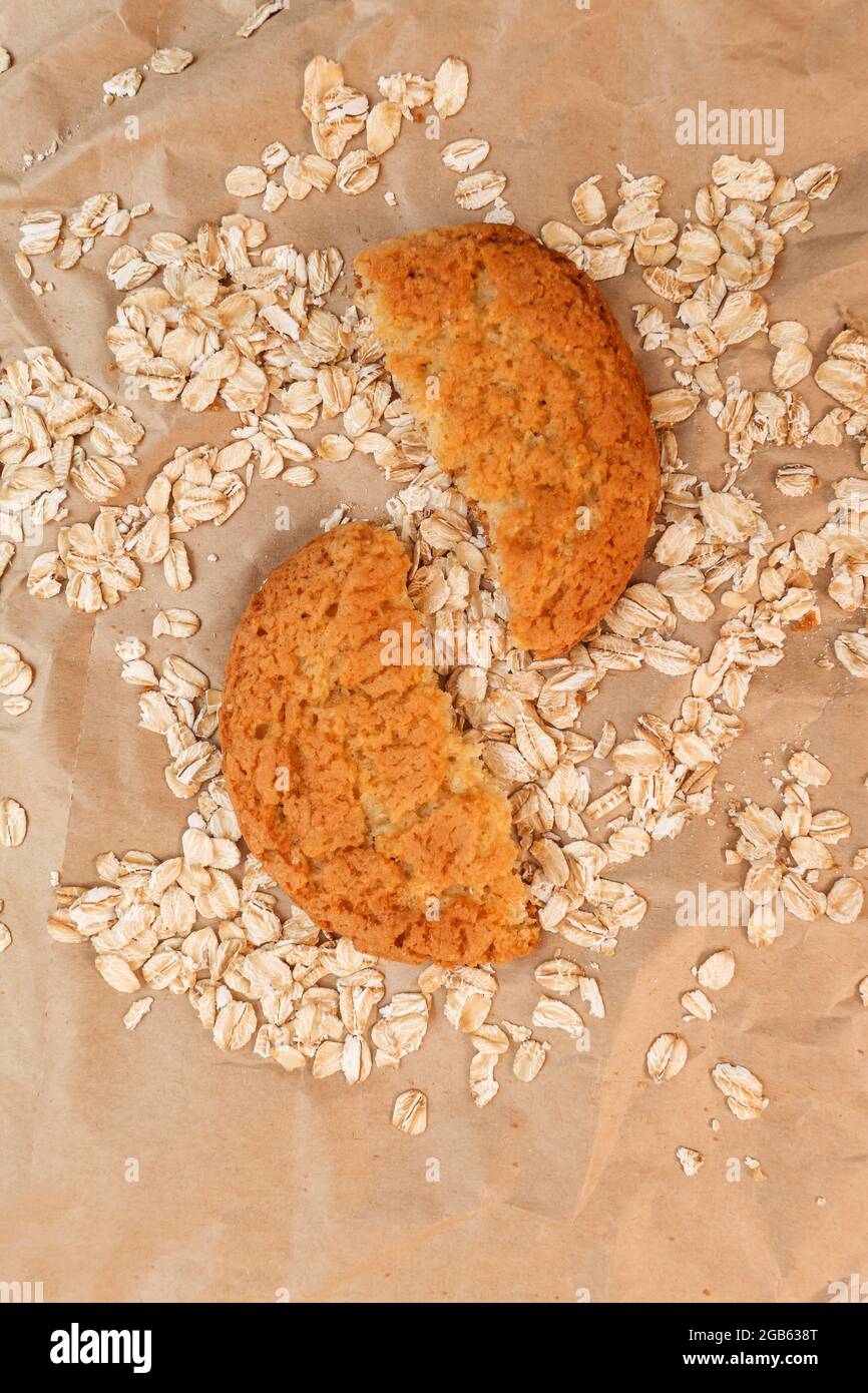 oatmeal cookies and scattered oatmeal on crumpled paper background ...