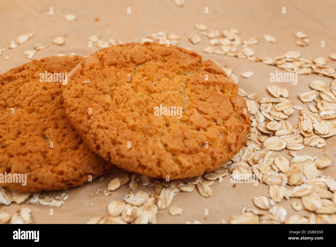oatmeal cookies and scattered oatmeal on crumpled paper background ...