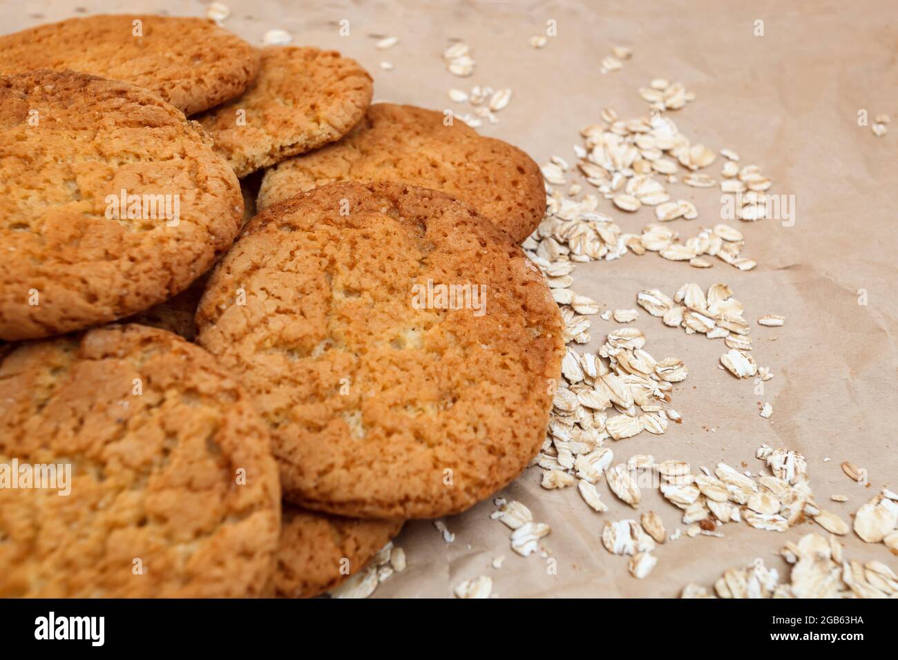 oatmeal cookies and scattered oatmeal on crumpled paper background ...