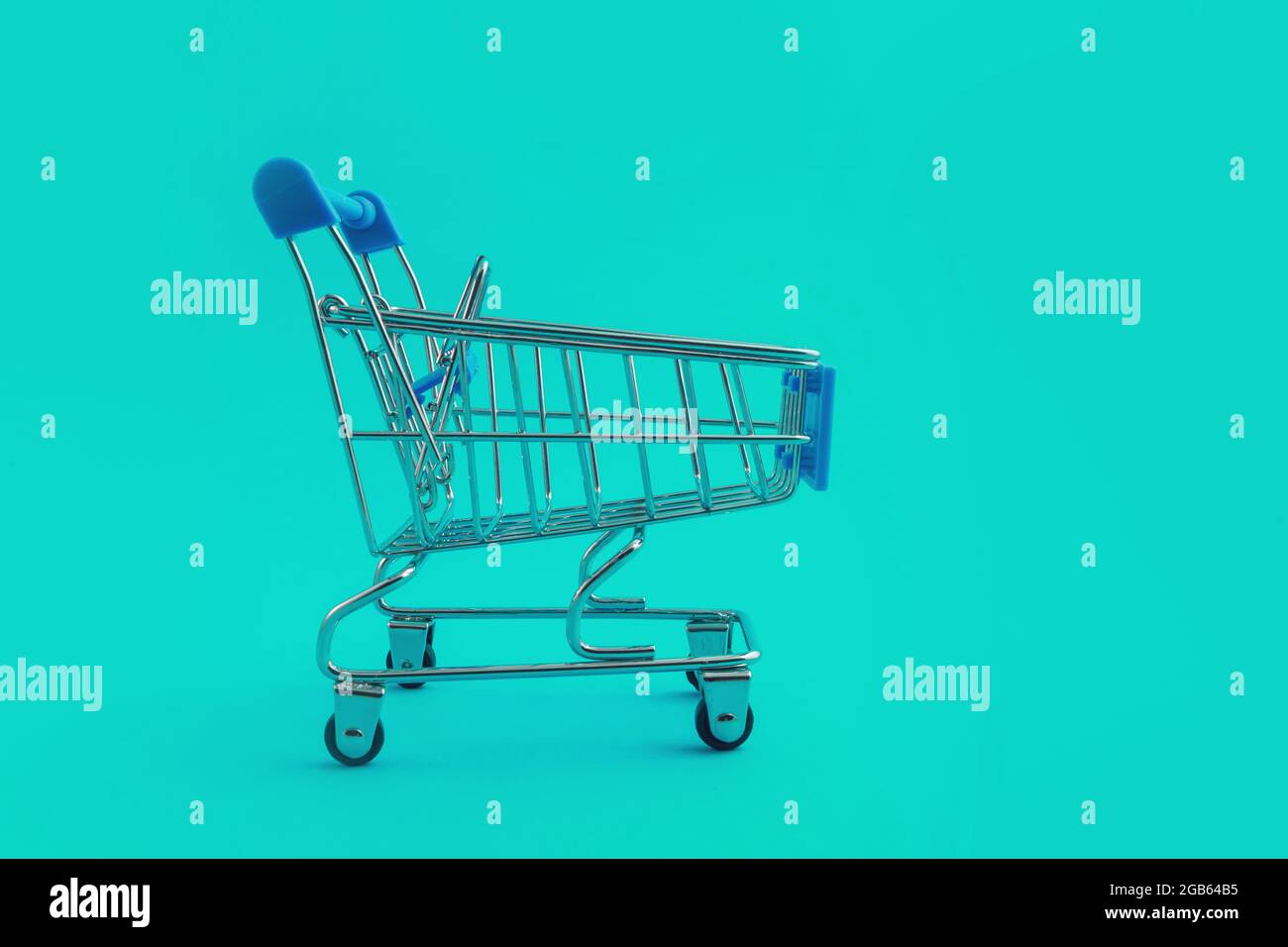 supermarket trolley on blue background Stock Photo - Alamy