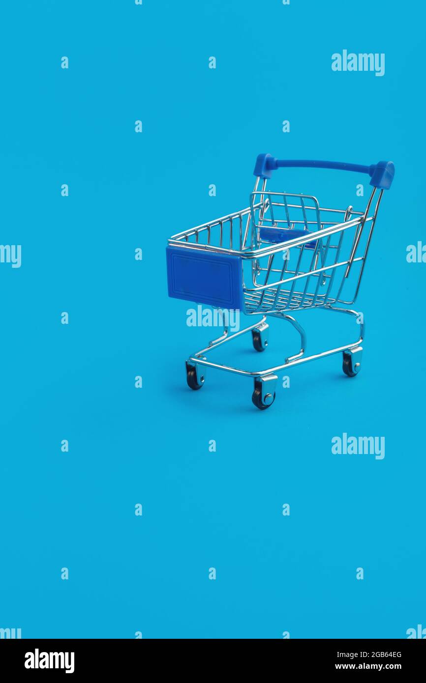 supermarket trolley on blue background Stock Photo - Alamy