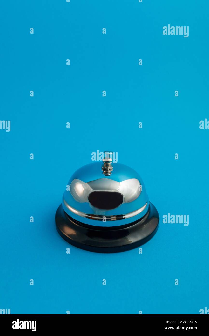 chrome bell for reception on a blue background Stock Photo - Alamy