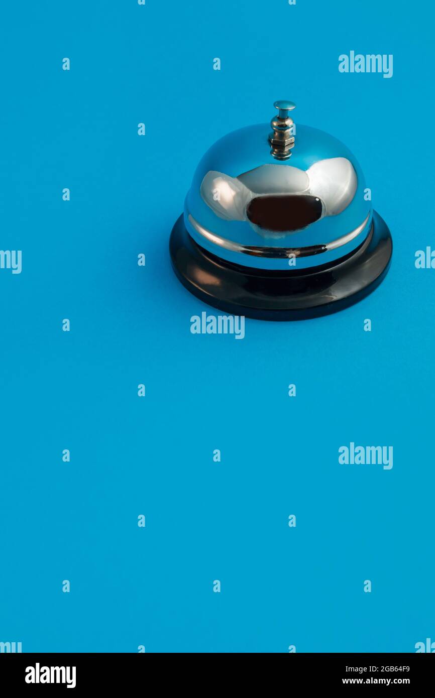 chrome bell for reception on a blue background Stock Photo - Alamy