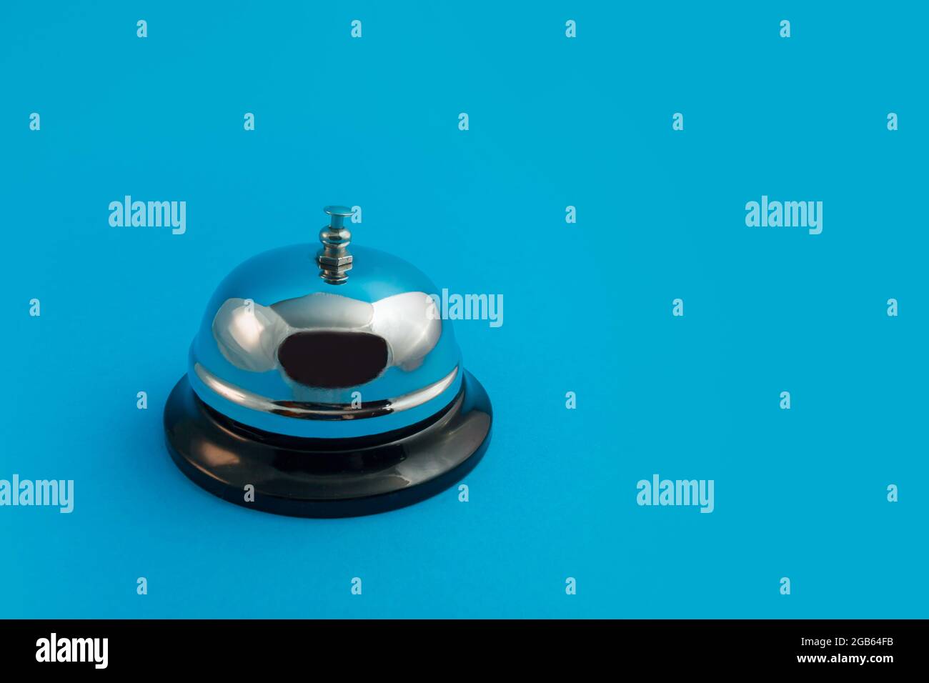 chrome bell for reception on a blue background Stock Photo - Alamy