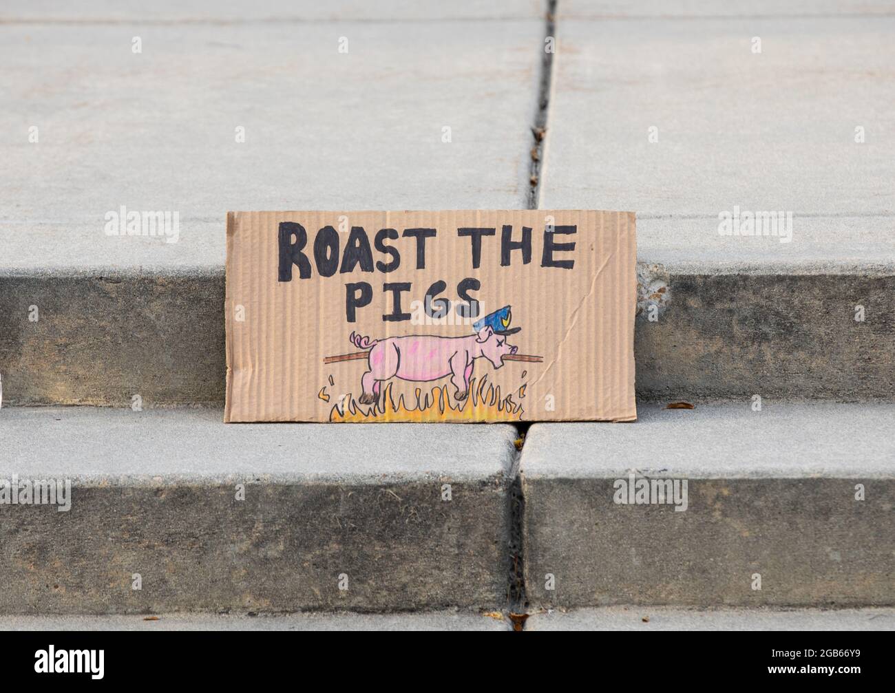 sign asking to roast the pigs during a protest Stock Photo - Alamy