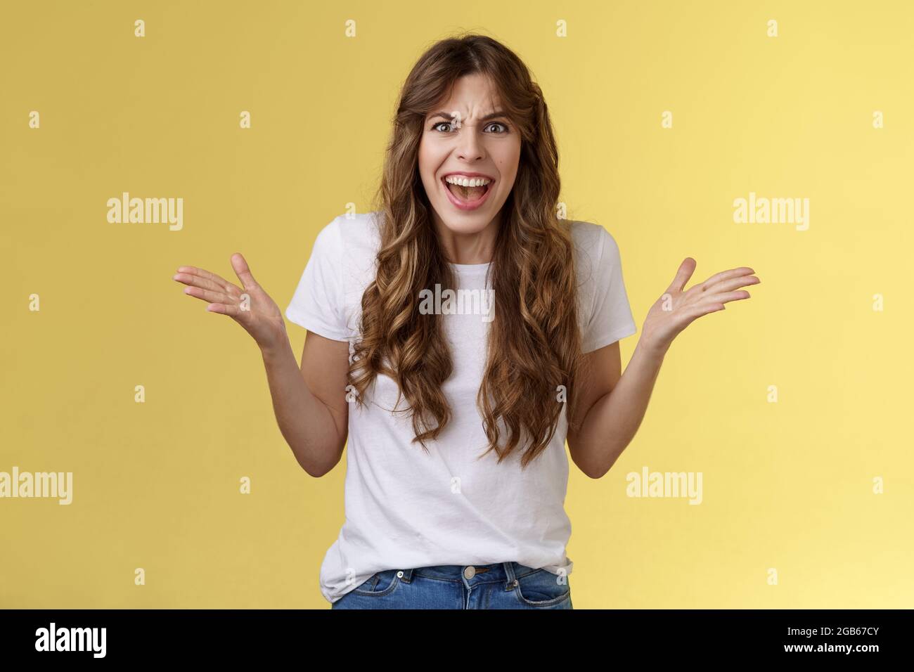 Disappointed angry furious woman shrugging hands sideways dismay ...