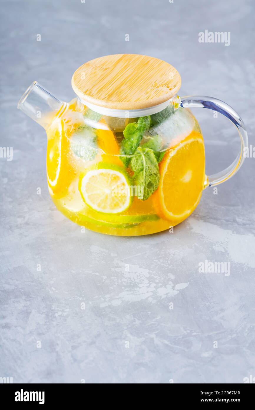 Detox lemonade drink of water, lemon, orange and mint leaves in a ...