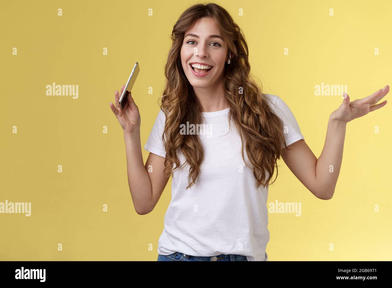 Sassy cheerful carefree attractive modern girl curly hairstyle having ...