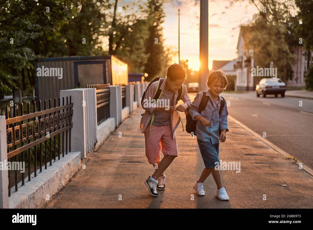 School boys running to school. School boys having fun after school ...