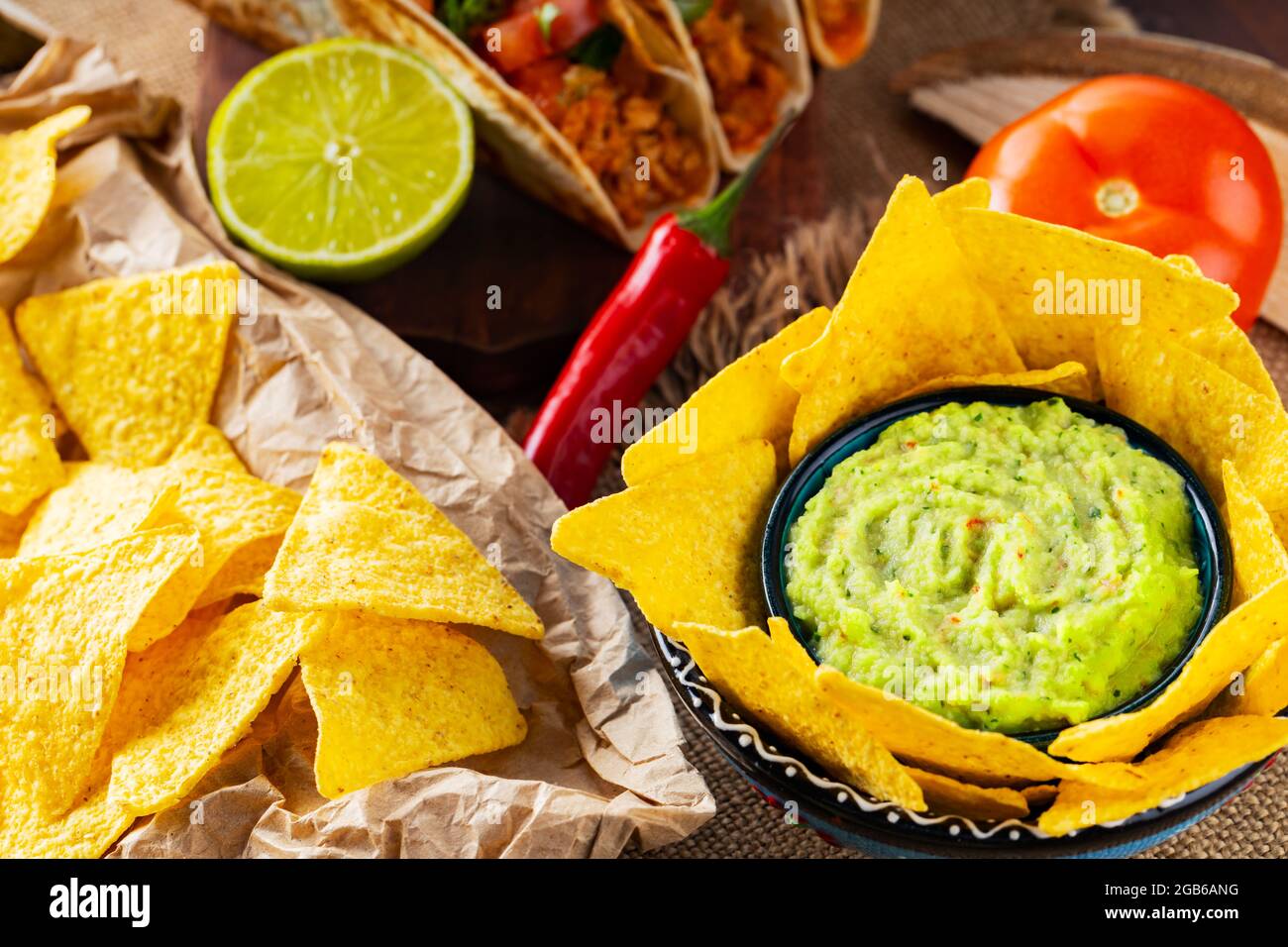 Mexican food table with nachos, guacamole, tacos and ingredients ...
