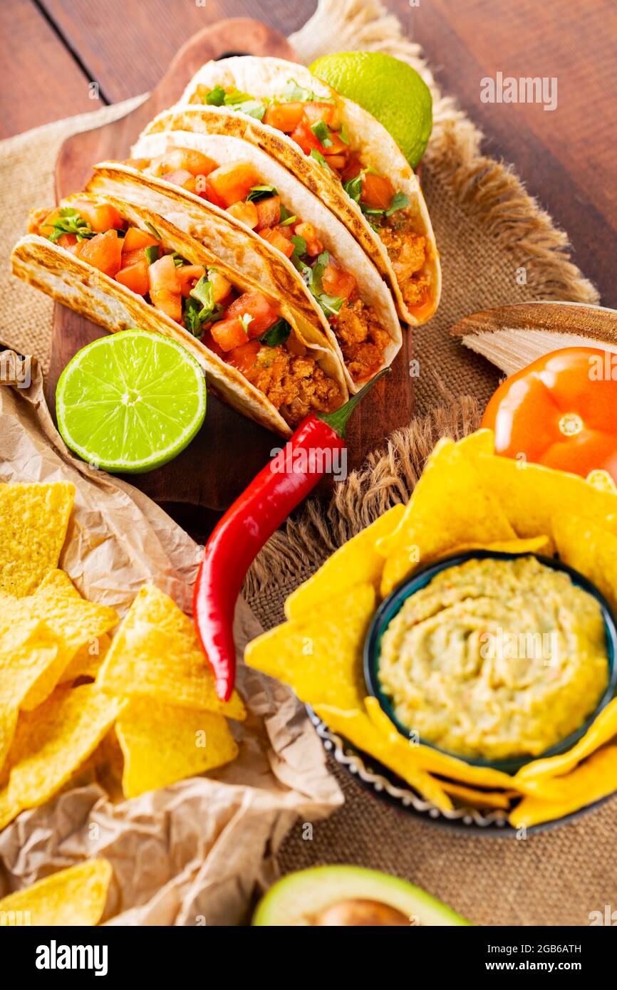 Mexican food table with nachos, guacamole, tacos and ingredients ...