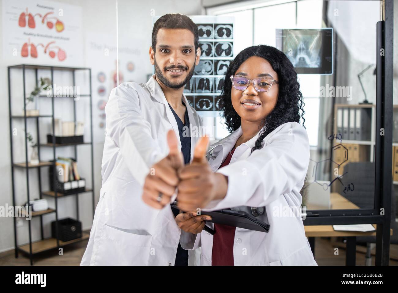 Diverse scientists showing thumbs up hi-res stock photography and ...
