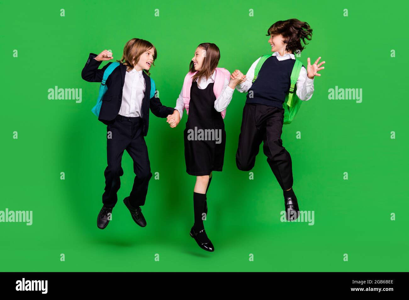 Full body photo of funky little girl boys jump talk wear school uniform ...