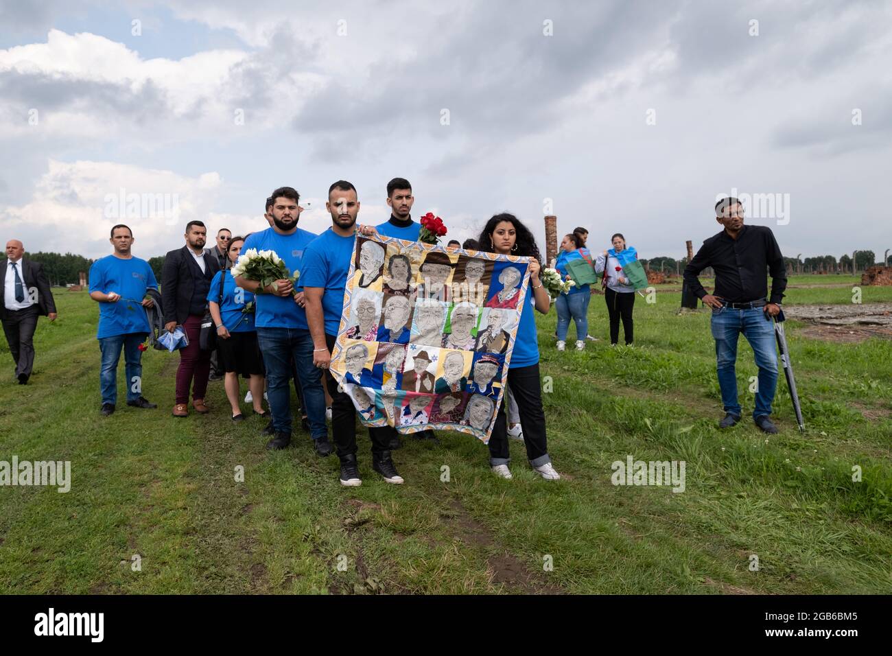 Brzezinka, Poland. 02nd Aug, 2021. A group of Gypsies holding a poster ...