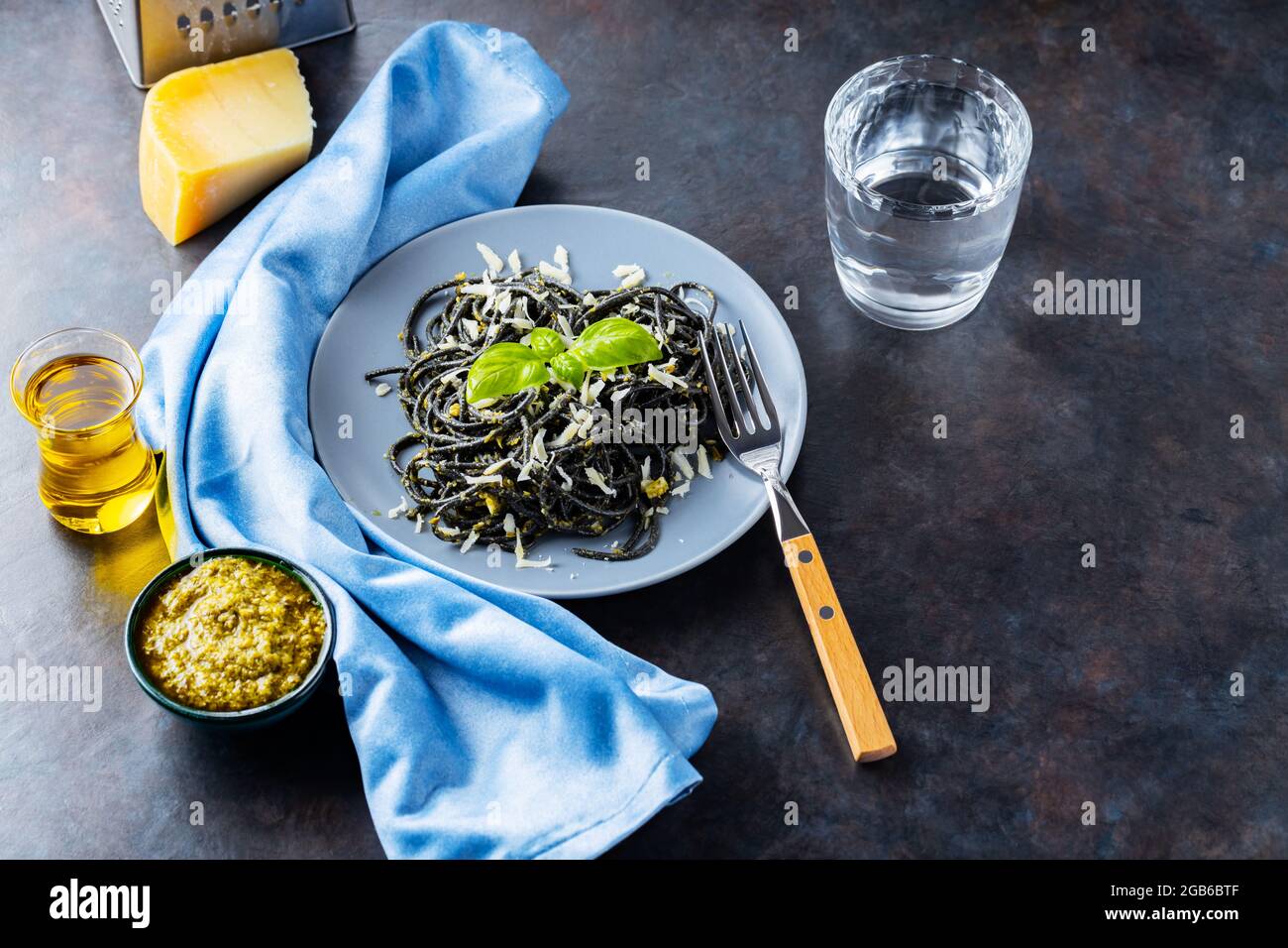 Black pasta with cuttlefish ink on a gray plate. Black spaghetti with ...