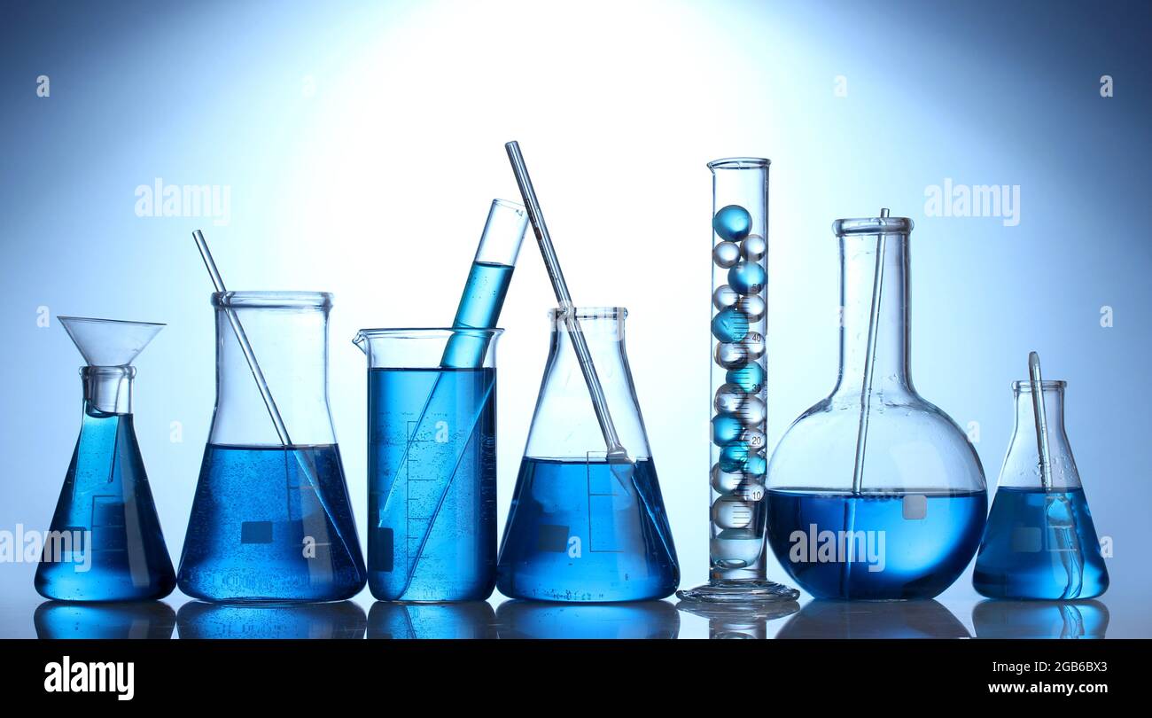 Test-tubes with blue liquid on blue background Stock Photo - Alamy