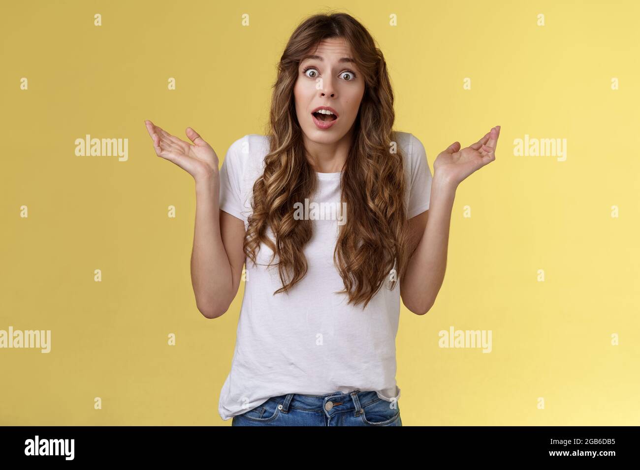 I not know. Clueless confused cute nervous young woman shrugging hands ...