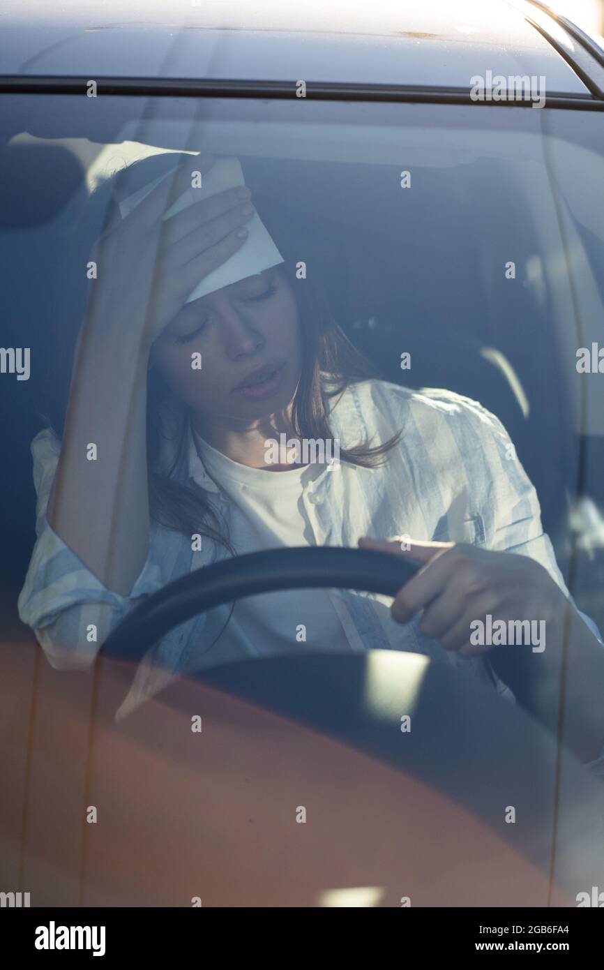 Woman driver being hot during heat wave in car, suffering from hot ...