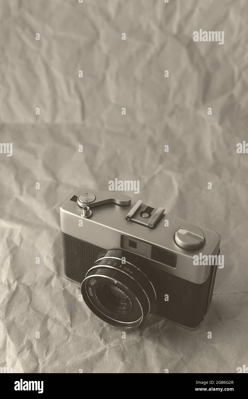 Vintage film camera on crumpled paper background. FED Mikron-2 ...