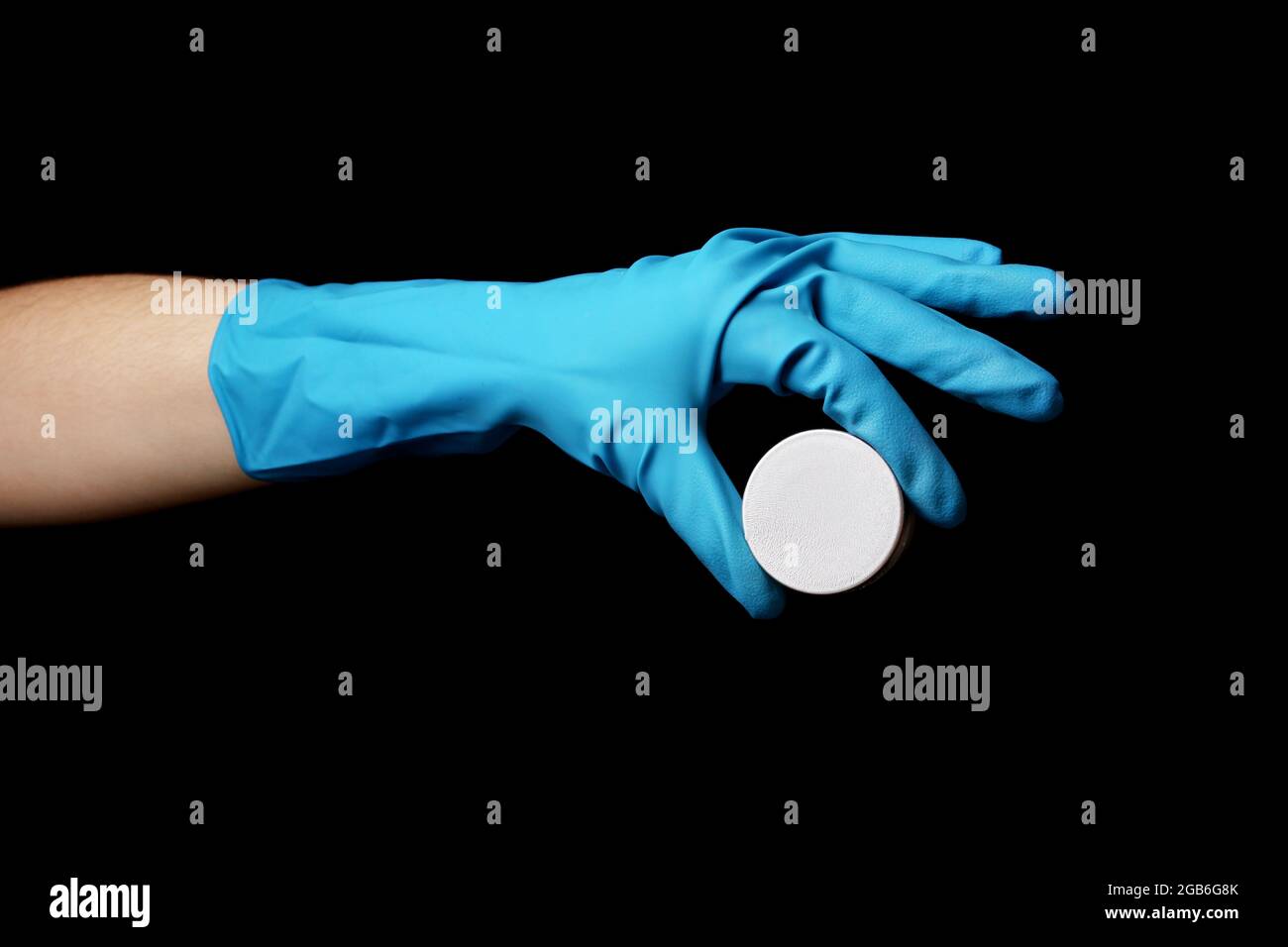 Uranium in hand isolated on black Stock Photo - Alamy