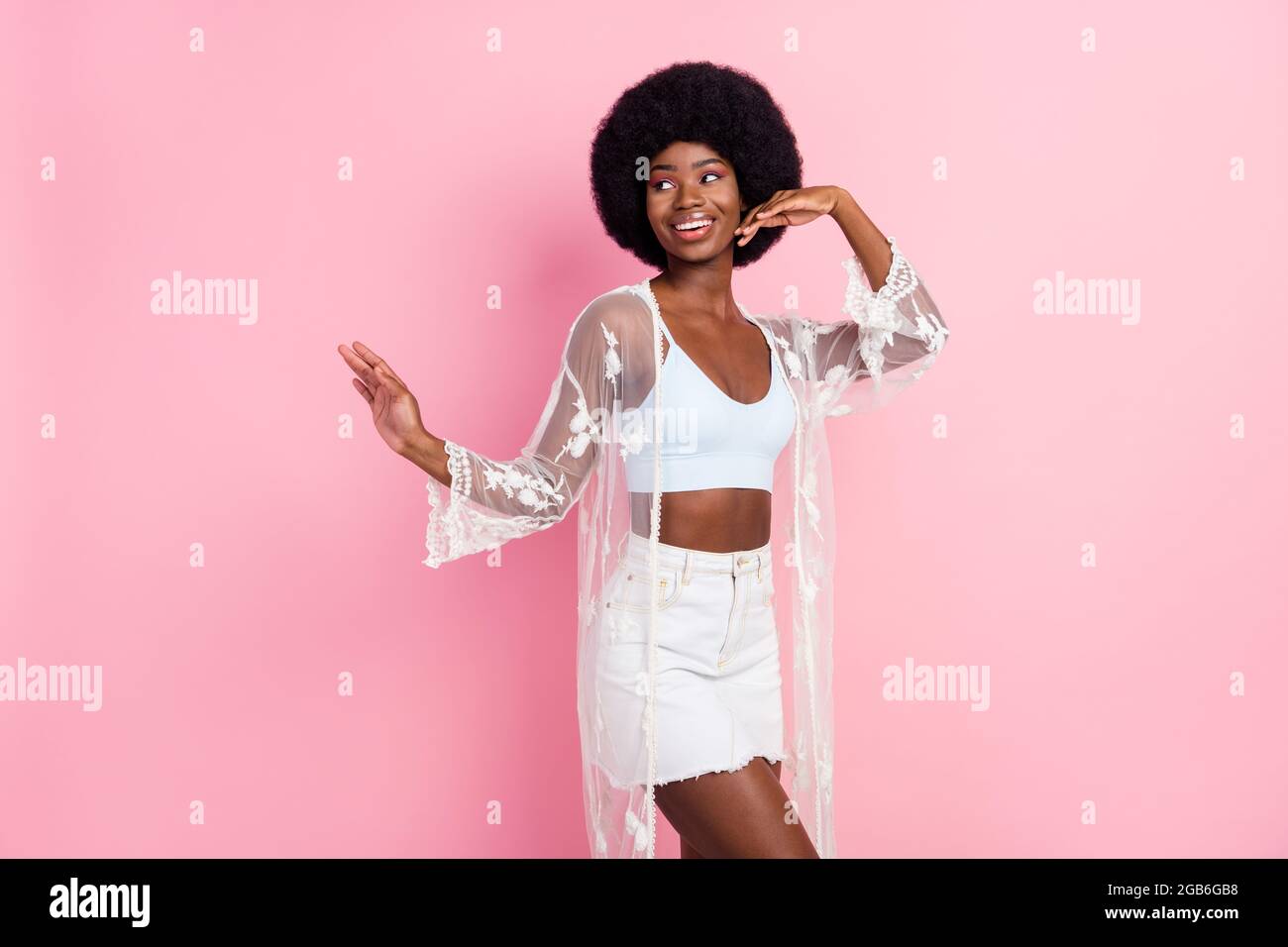 Photo Of Dreamy Happy Young Dark Skin Woman Look Empty Space Dance Isolated On Pink Color