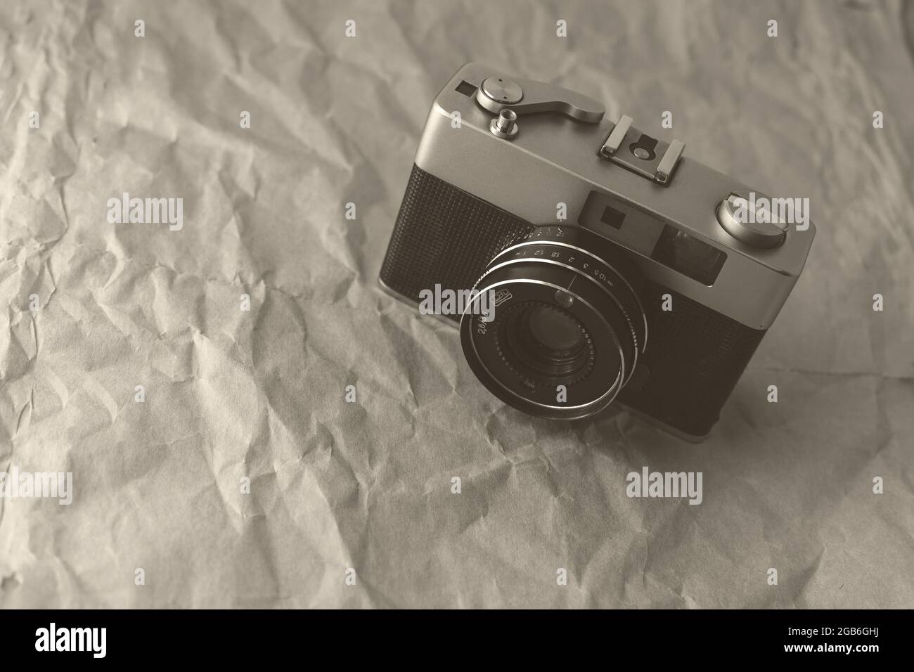 Vintage film camera on crumpled paper background. FED Mikron-2 ...