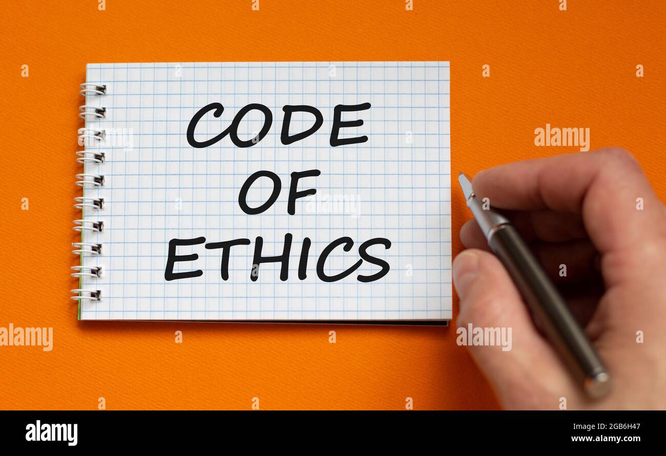Code of conduct symbol. Businessman writing words 'Code of ethics' on ...
