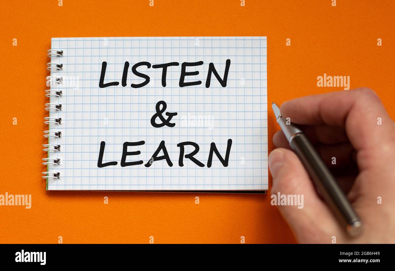 Listen and learn symbol. Businessman writing words 'Listen and learn ...