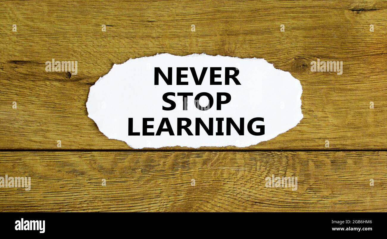 Never stop learning symbol. Words 'Never stop learning' on white paper ...