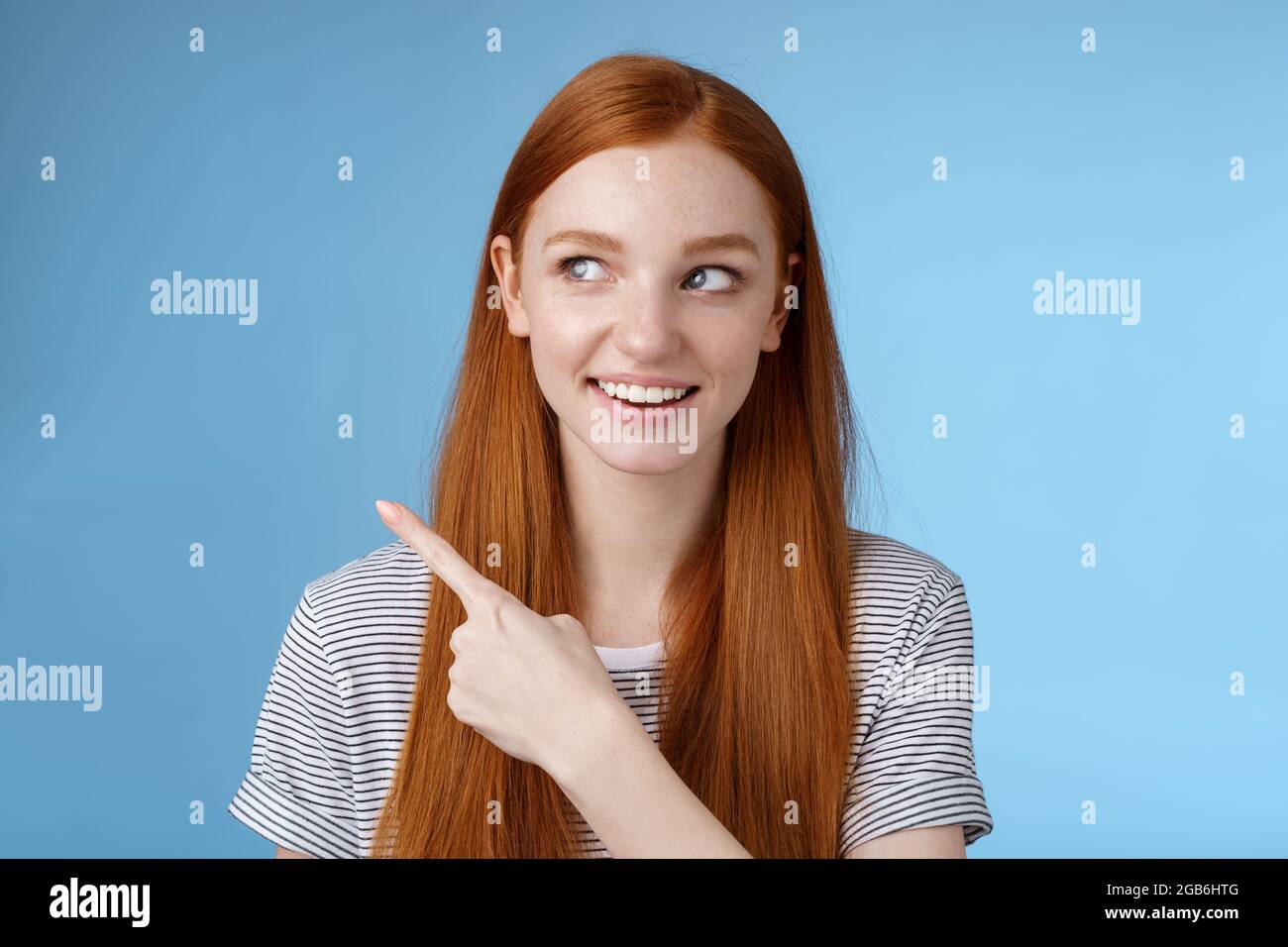 Intrigued good-looking redhead joyful curious girl watching looking ...