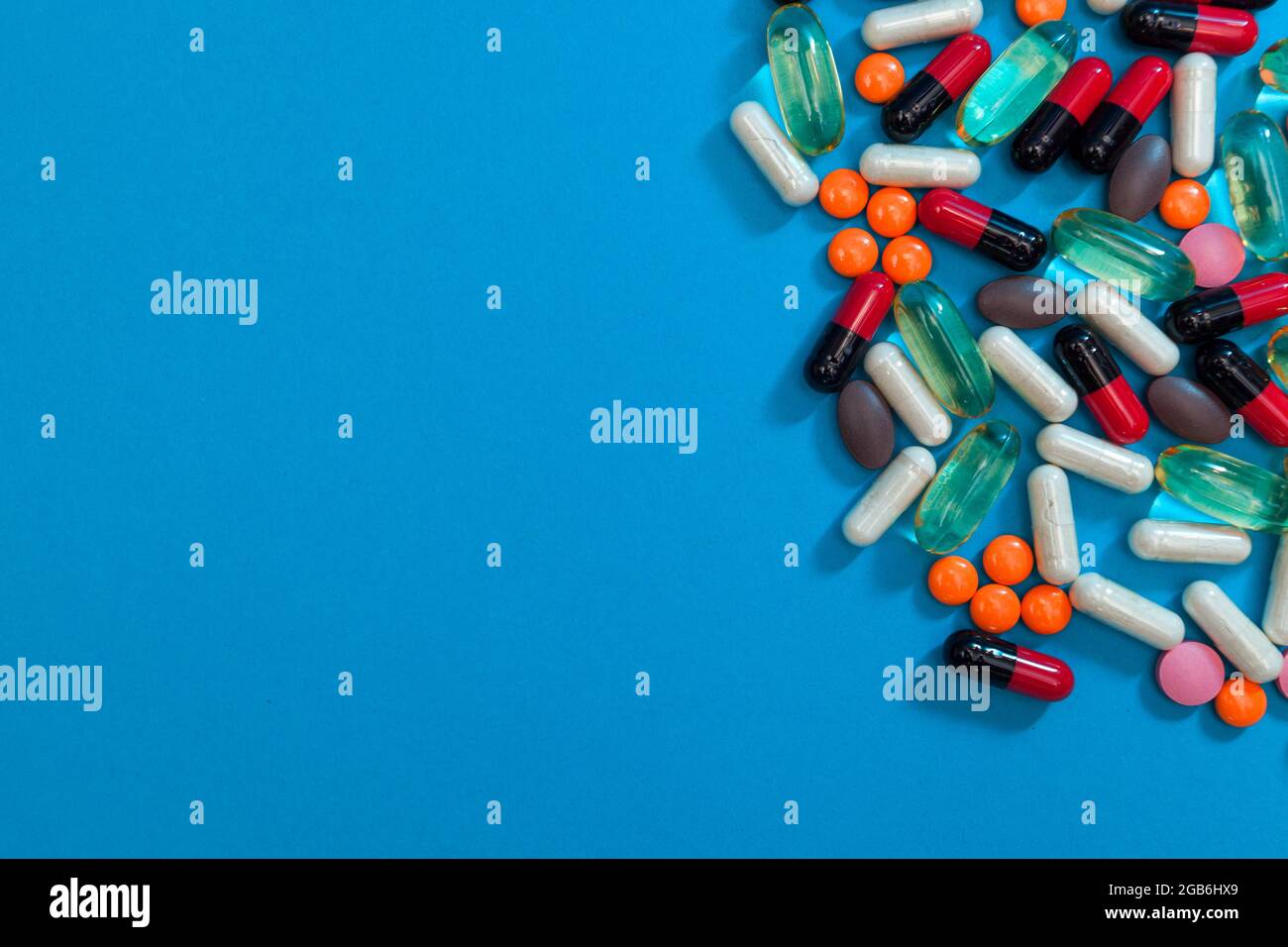 multicolored pills texture on blue background Stock Photo - Alamy