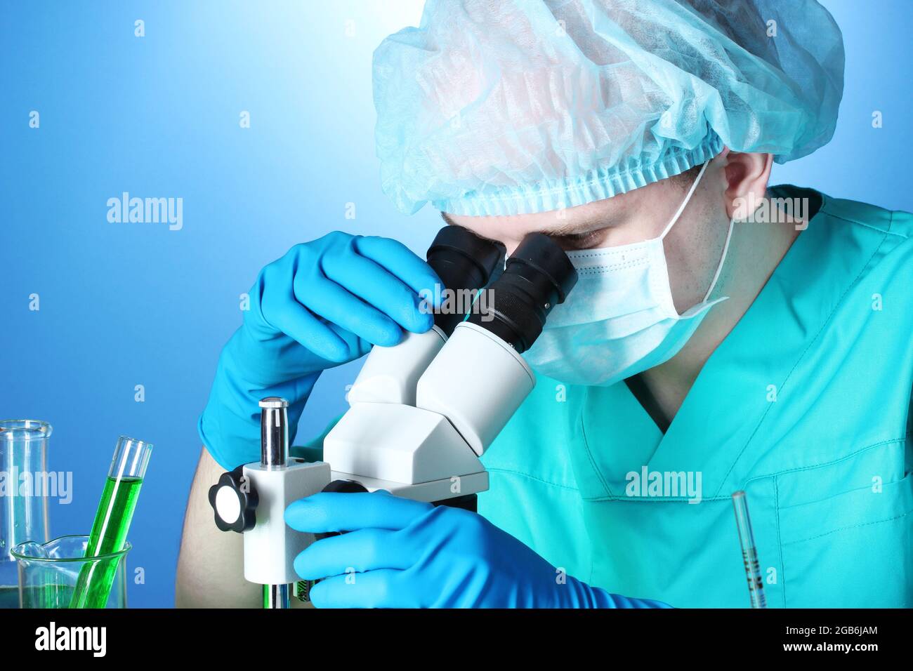 scientist looking at microscope in chemistry laboratory Stock Photo - Alamy