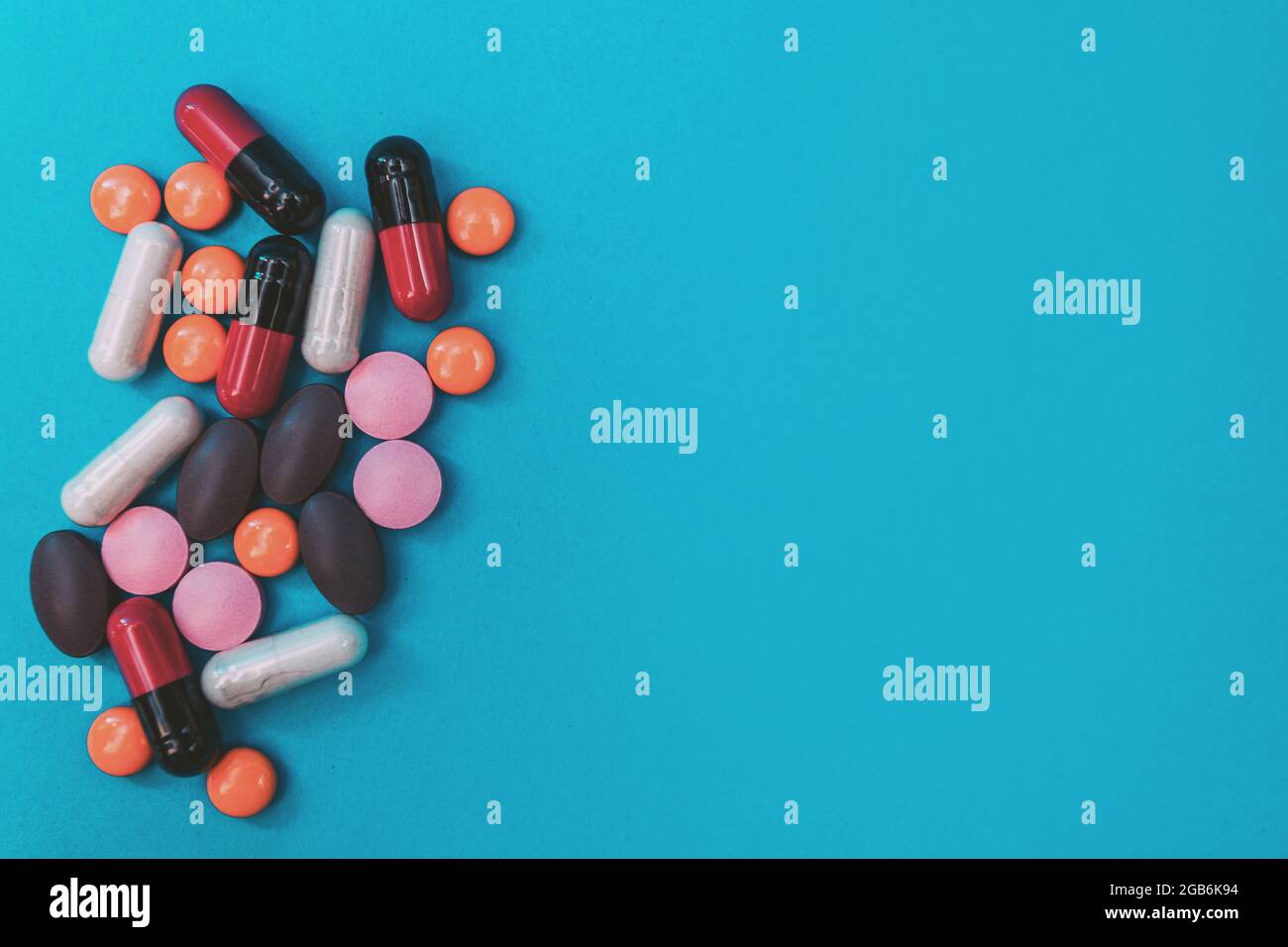 multicolored pills texture on blue background Stock Photo - Alamy