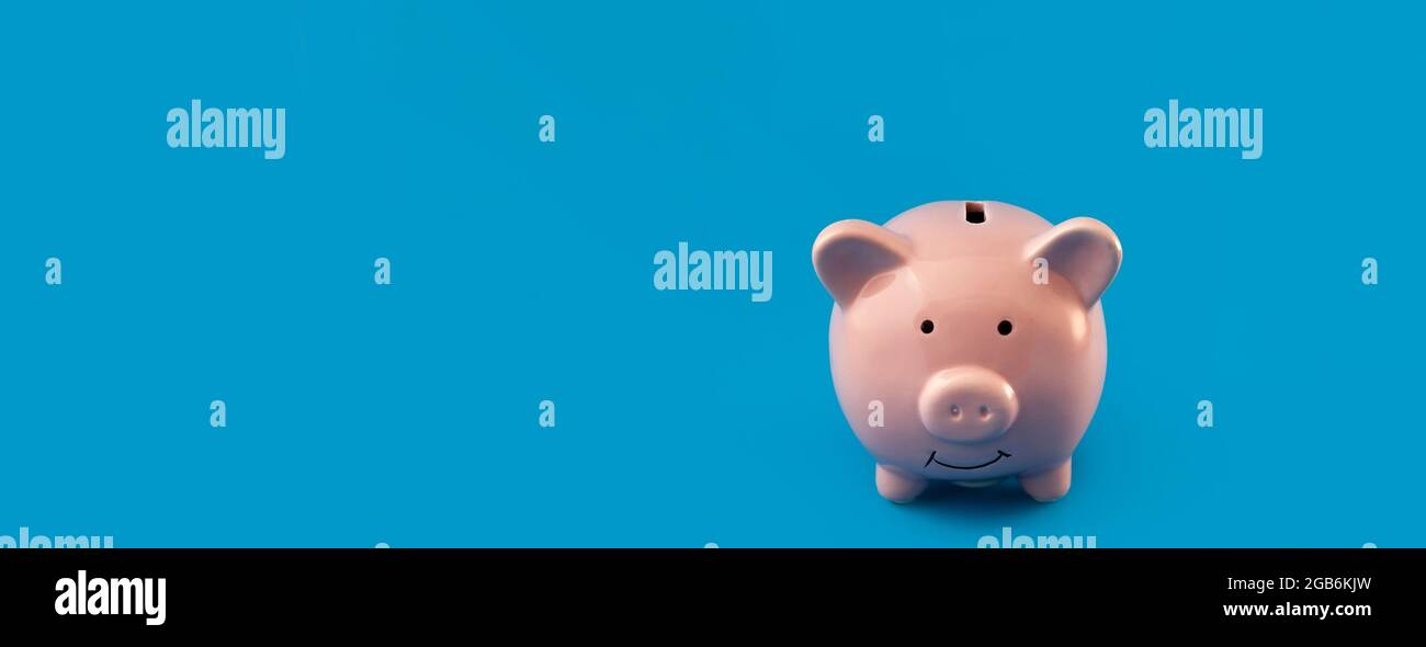 red piggy bank on blue panorama background Stock Photo - Alamy