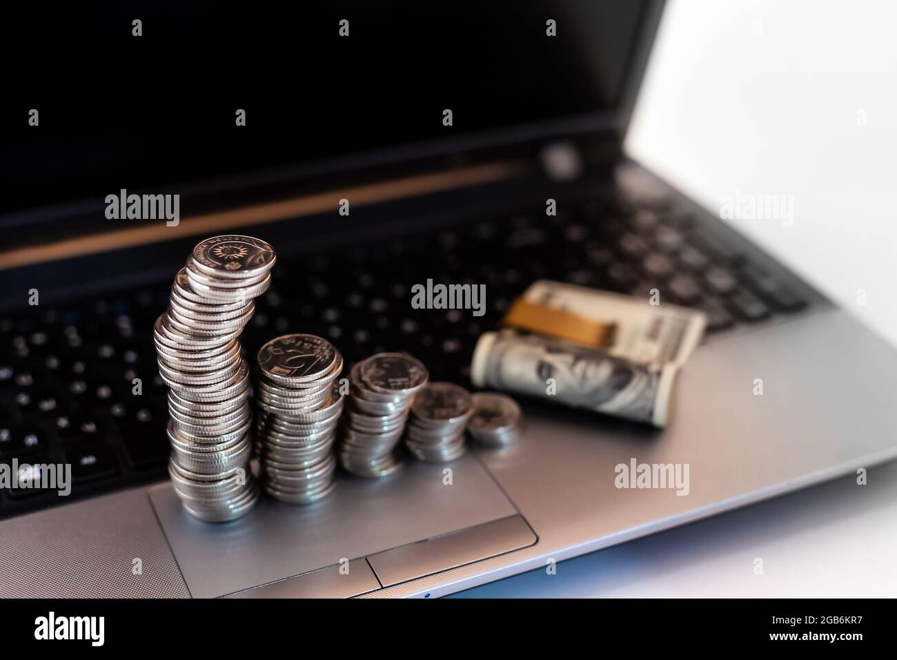coins in the form of a graph on the background of a laptop graphics ...