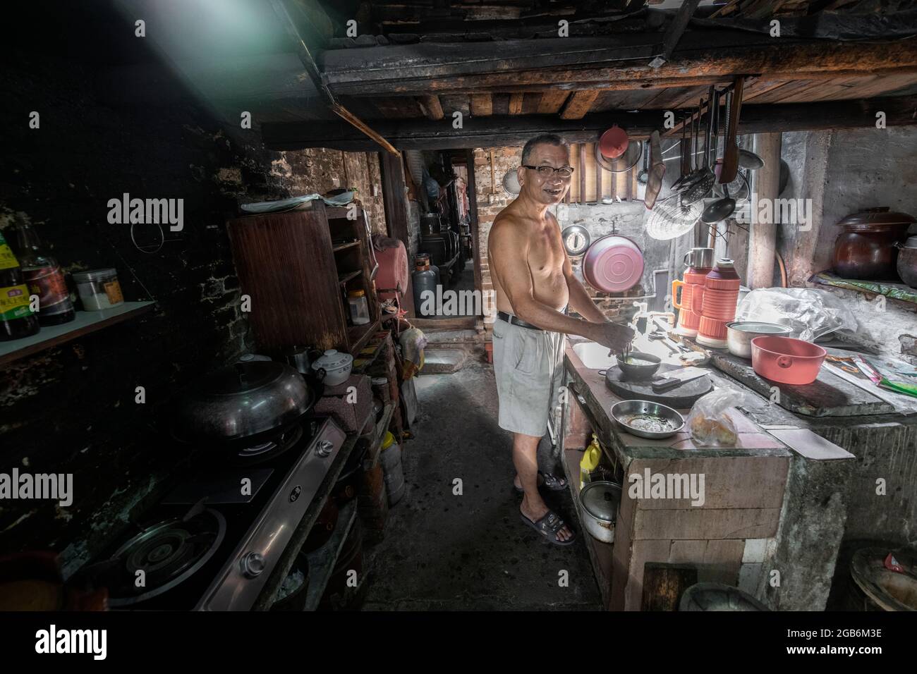 A Chinese man cooks in the kitchen of his house in a village in China Stock Photo - Alamy
