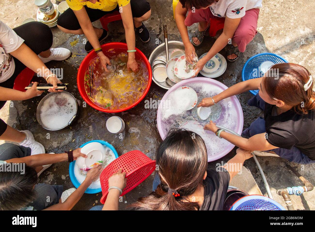 Women wash up their crockery, chopsticks and cutlery inside the Ancient ...